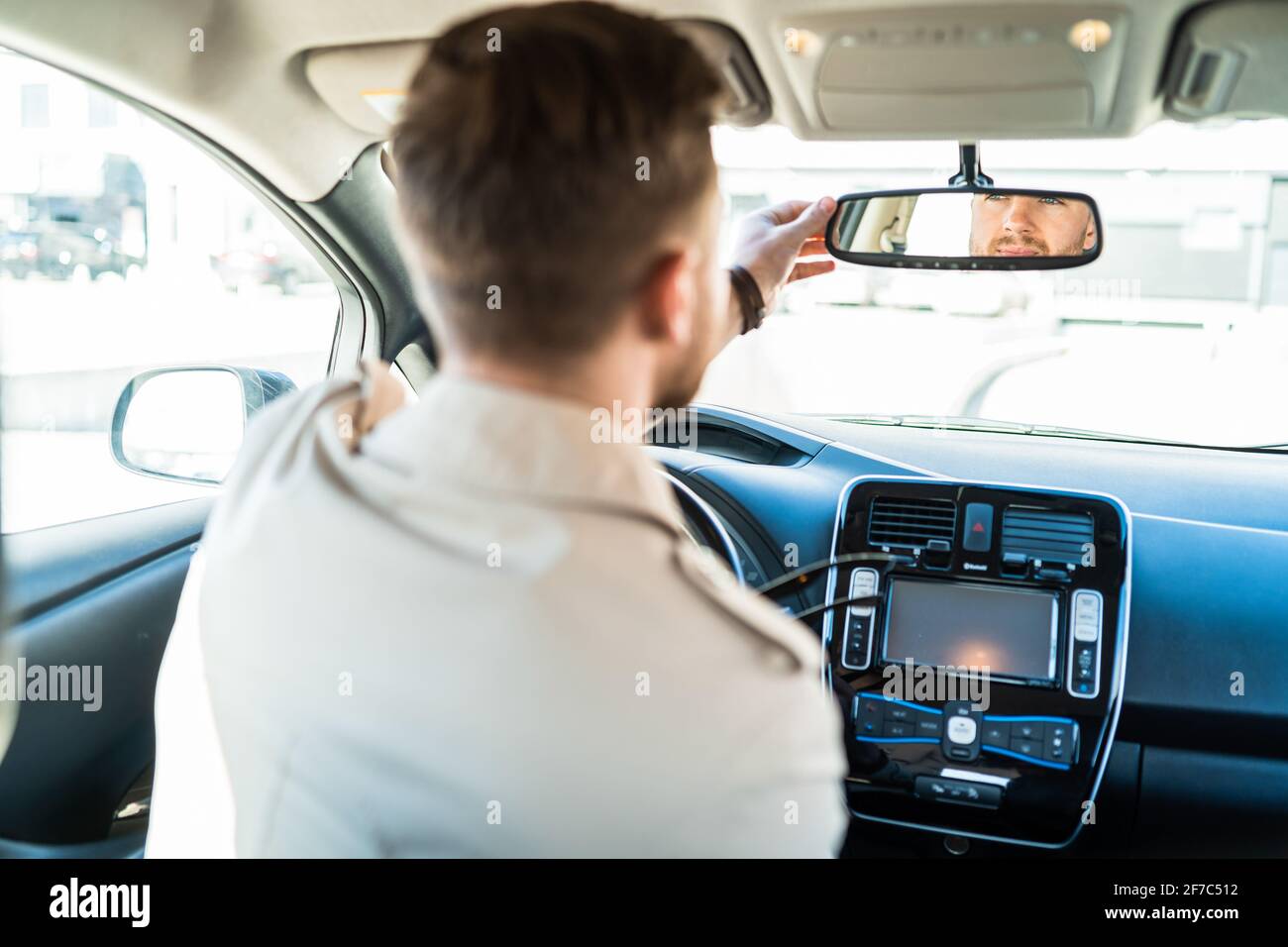 Man Looking In Rearview Mirror
