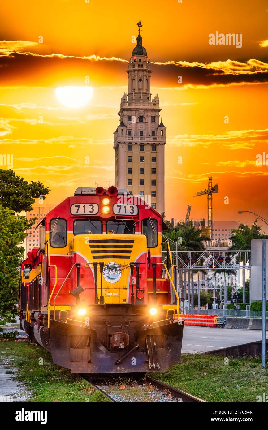 Red and yellow locomotive in front of Freedom Tower during vibrant ...