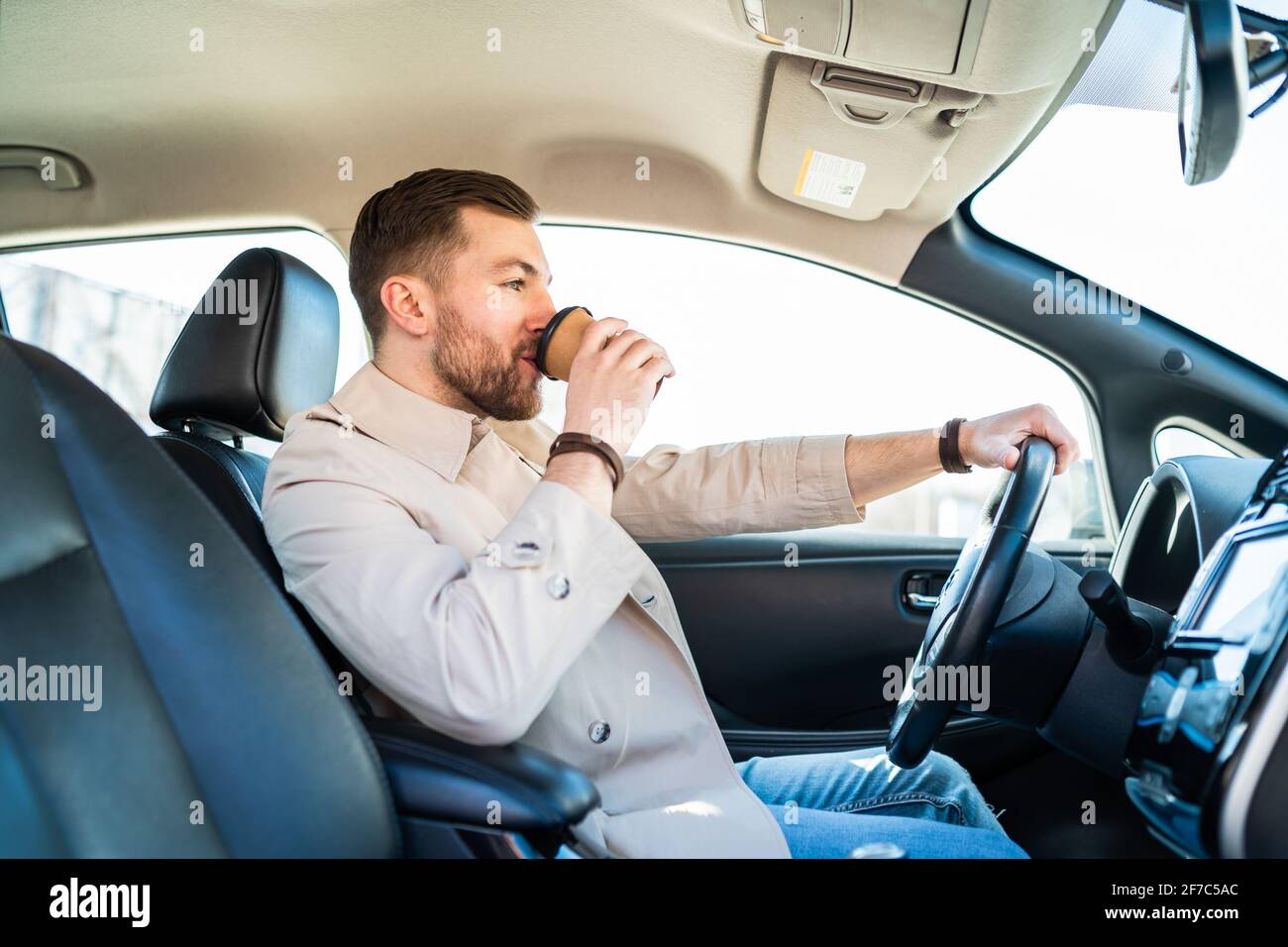 Man drinking coffee driving car hi-res stock photography and images - Alamy