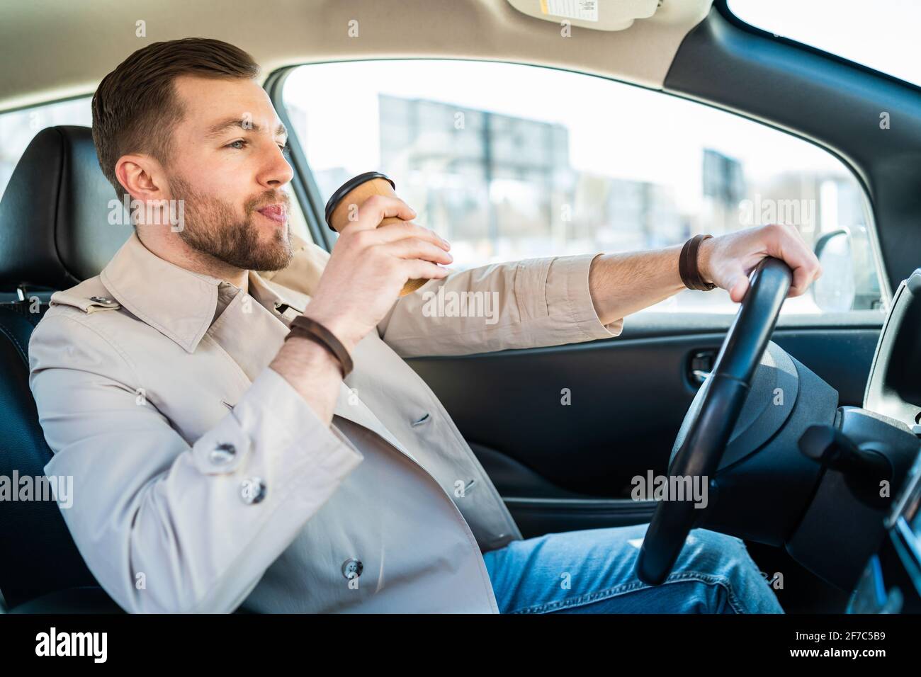 Man drinking coffee driving car hi-res stock photography and images - Alamy
