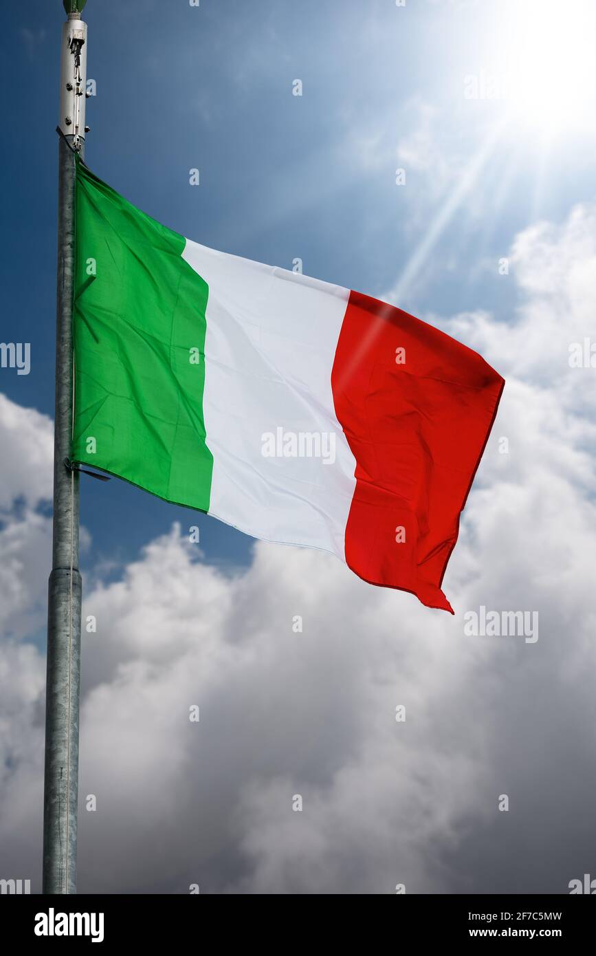 Closeup of a national Italian flag with flagpole, blowing in the wind ...