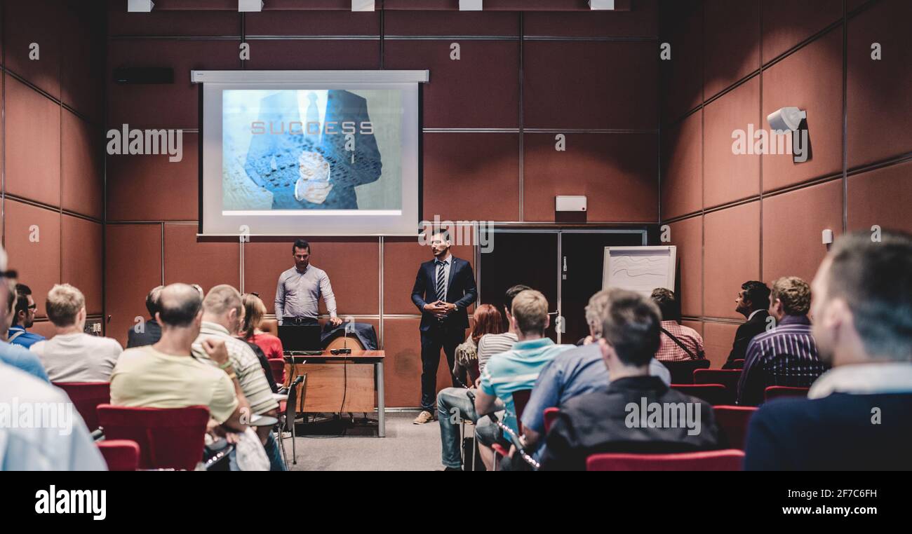 Business speaker giving a talk at business conference meeting event ...