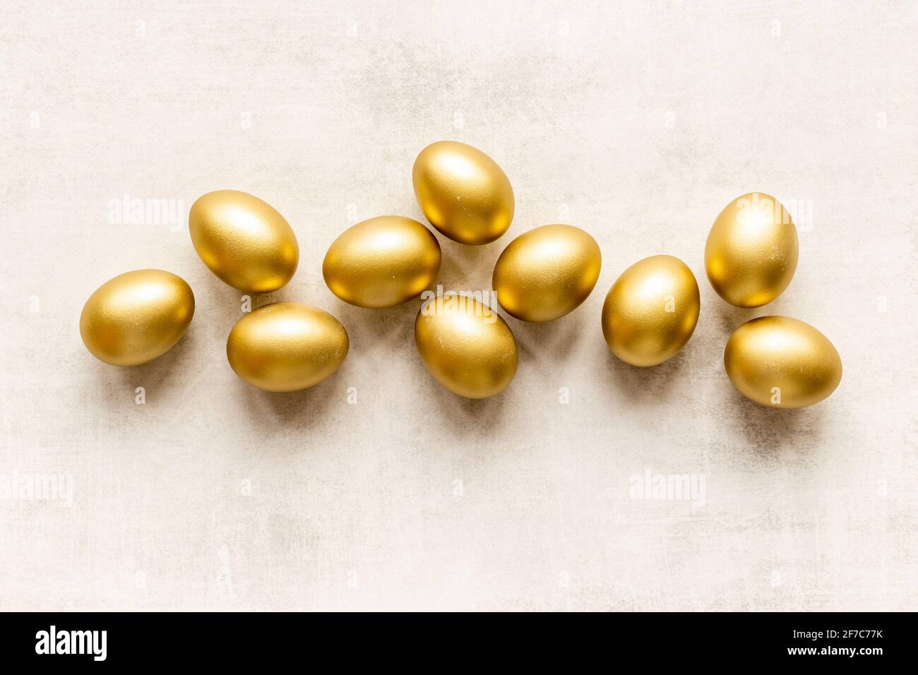 Golden eggs flat lay. Save money. Wealth and good luck symbol Stock ...