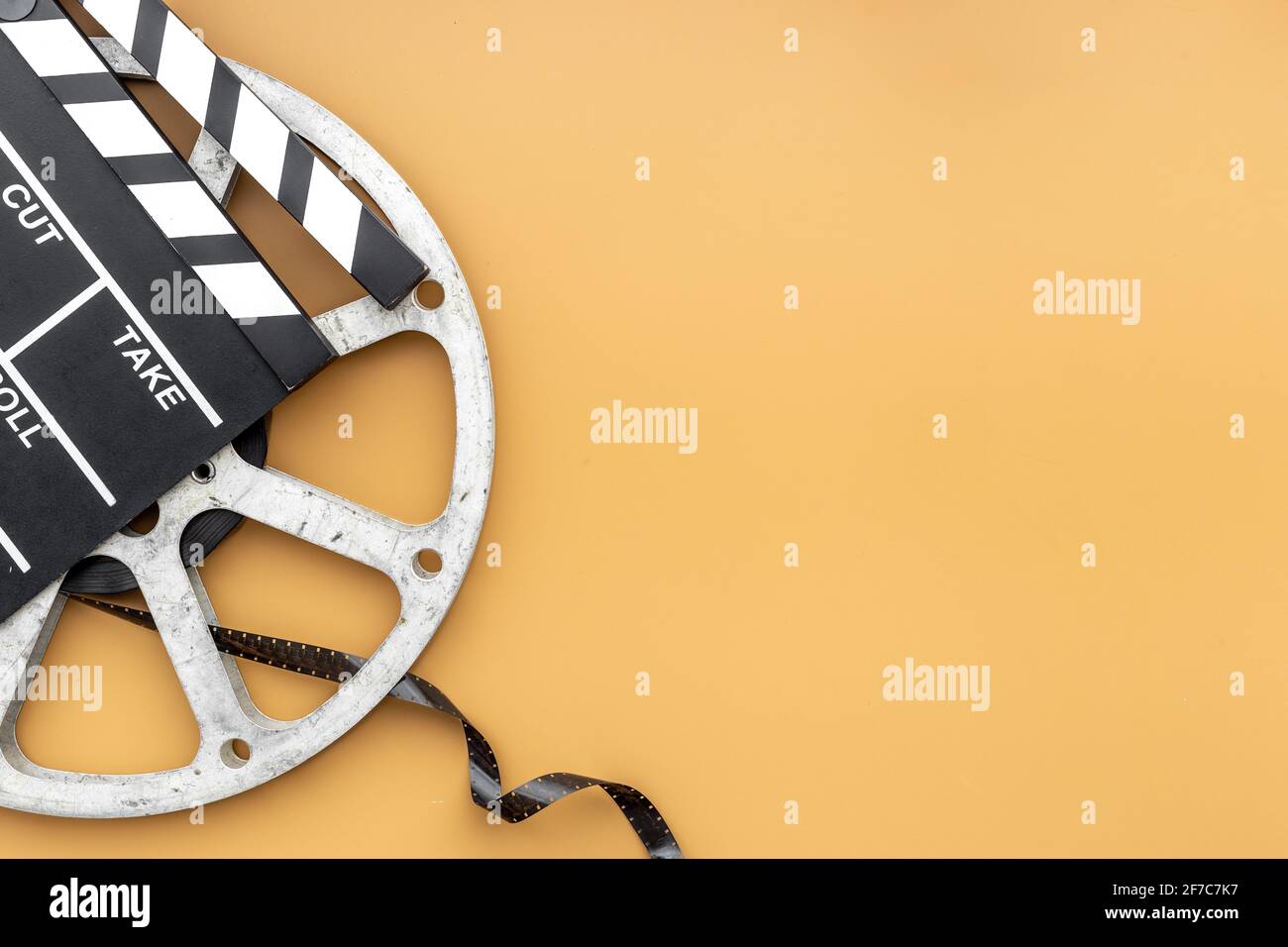 Movie clapper with film reel. Cinema background Stock Photo - Alamy