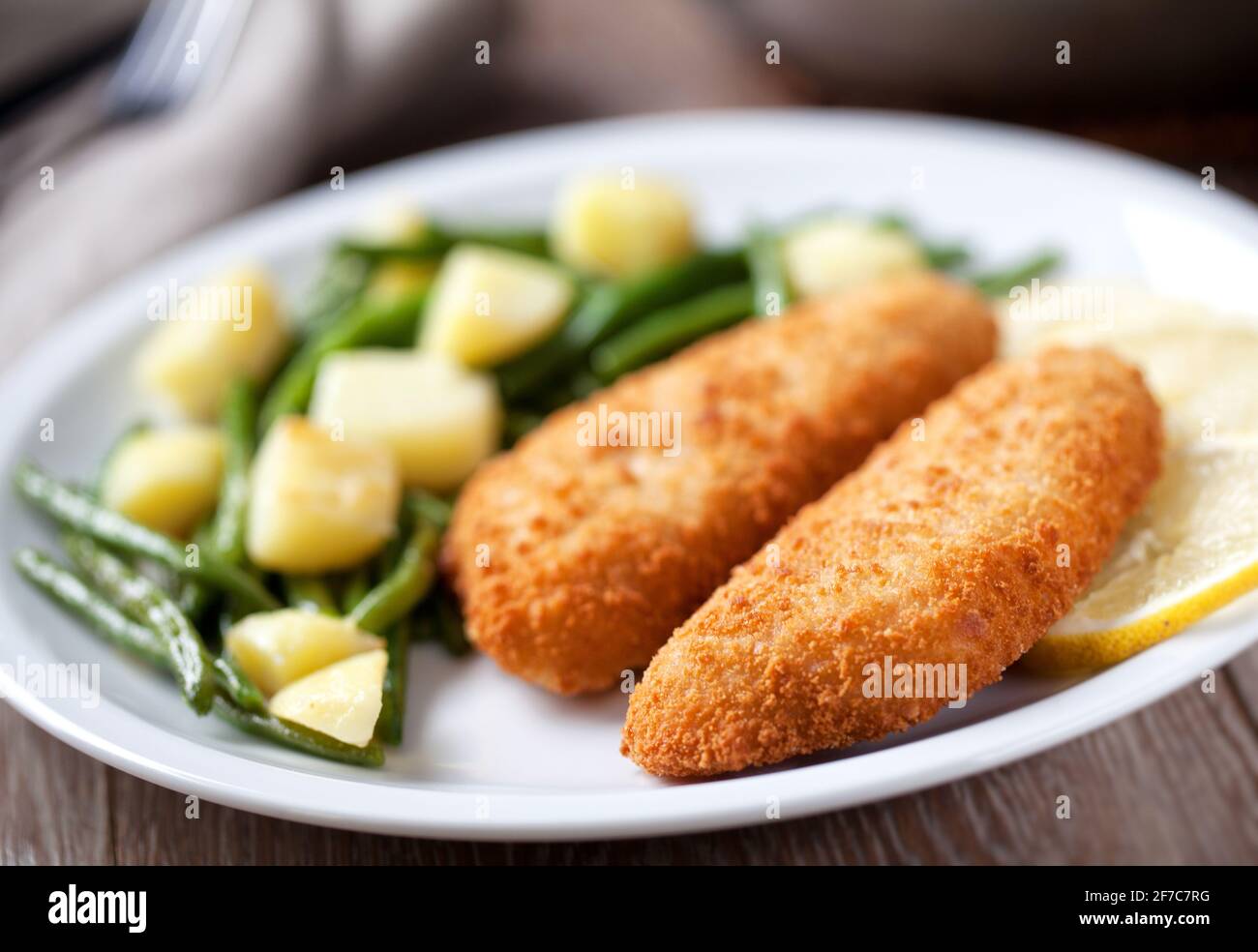 Breaded Fish Fillet with Potatoes and Green Beans Stock Photo - Alamy