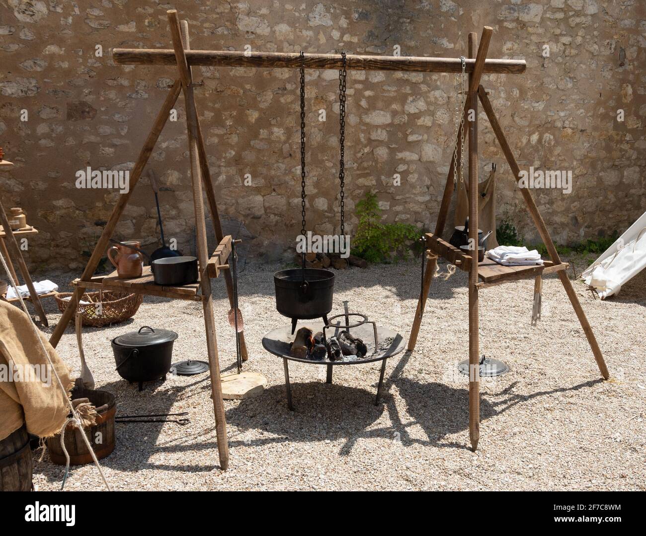 Medieval meal is prepared in cauldron on an open fire at traditional ...