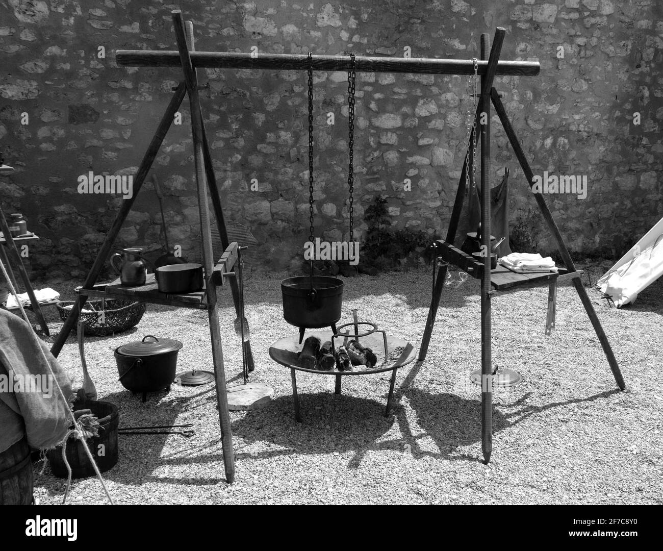 Medieval meal is prepared in cauldron on an open fire at traditional ...