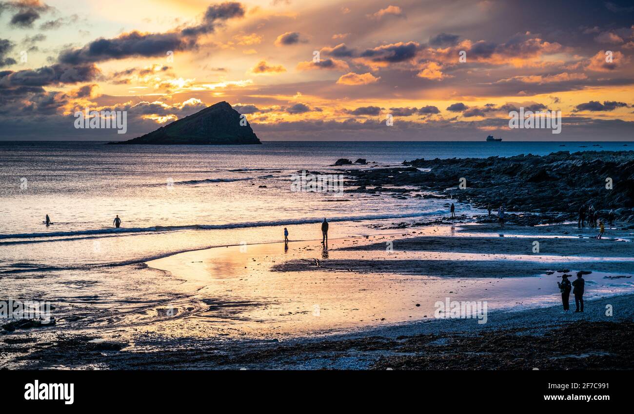 Late afternoon beach scene with bathers and Great Mew Stone in distance ...