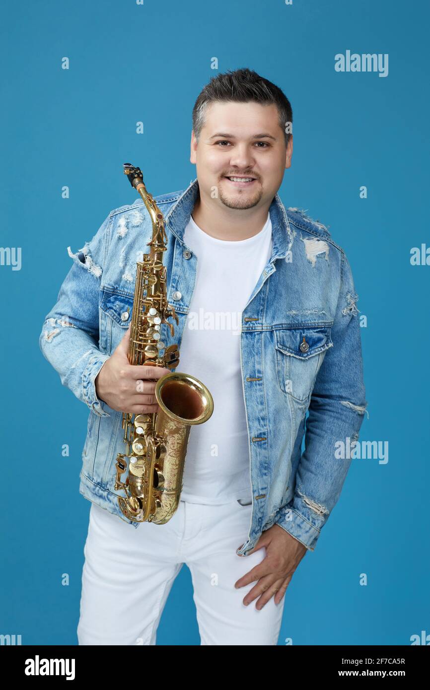 musician man with the saxophone on studio background Stock Photo - Alamy