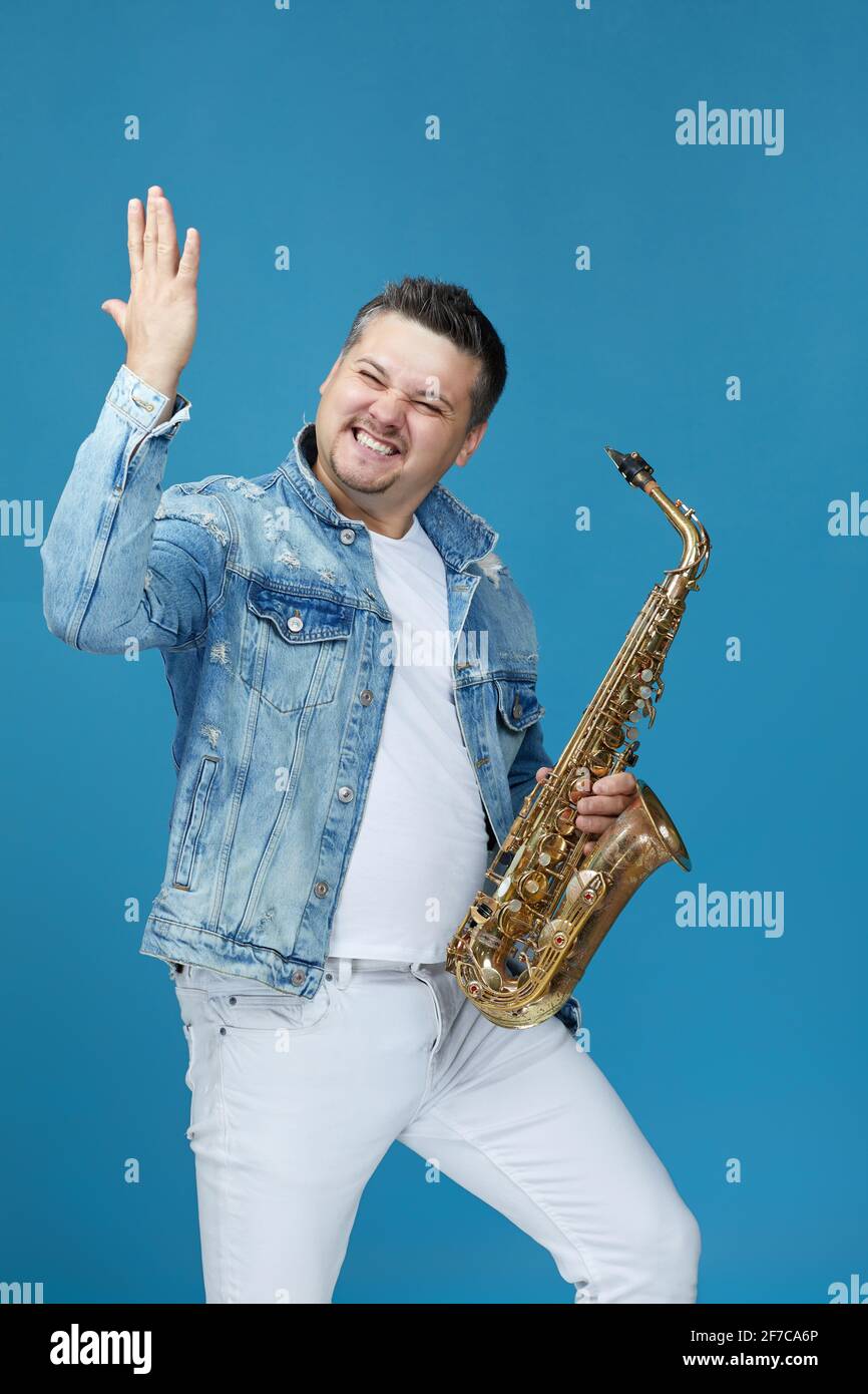 musician man with the saxophone on studio background Stock Photo - Alamy