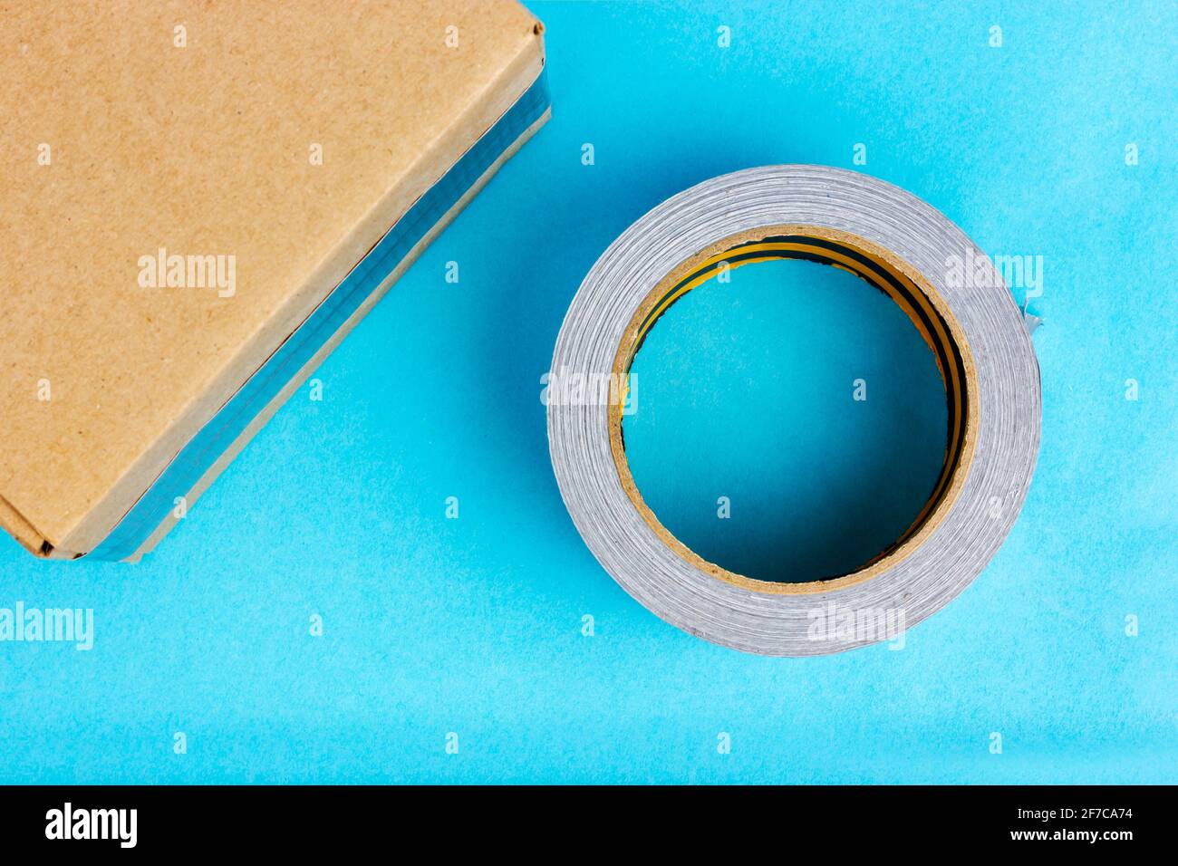 Sealing the cardboard box with packing tape. Scotch tape for packing ...