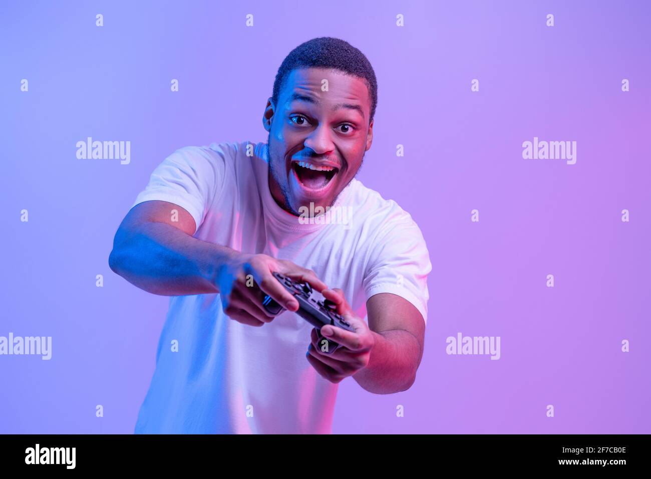 Online Competition Concept. Excited black guy playing video games with ...