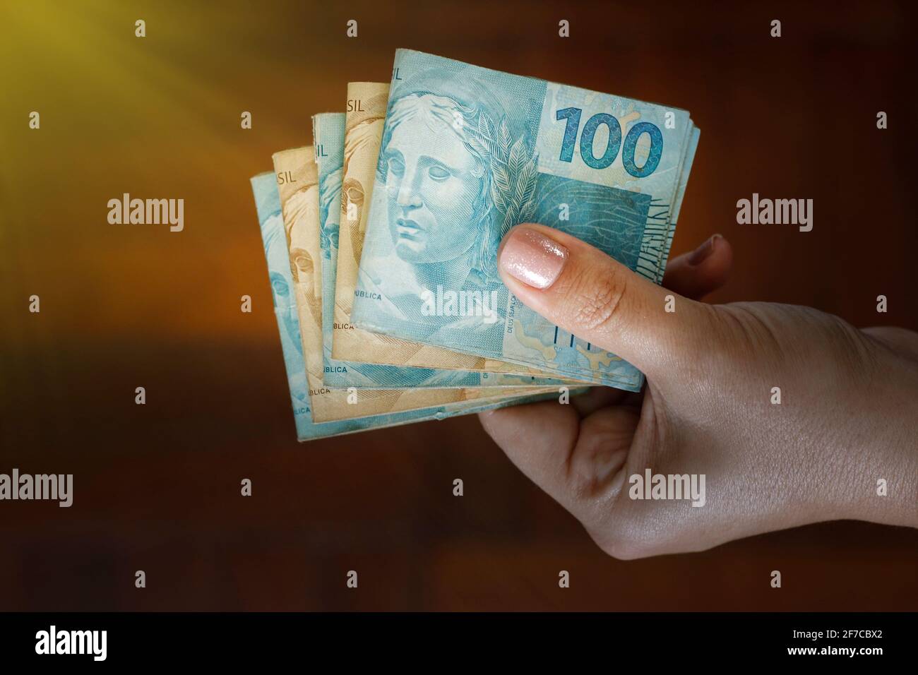 Hands holding Brazilian real notes, money from Brazil, notes of Real ...