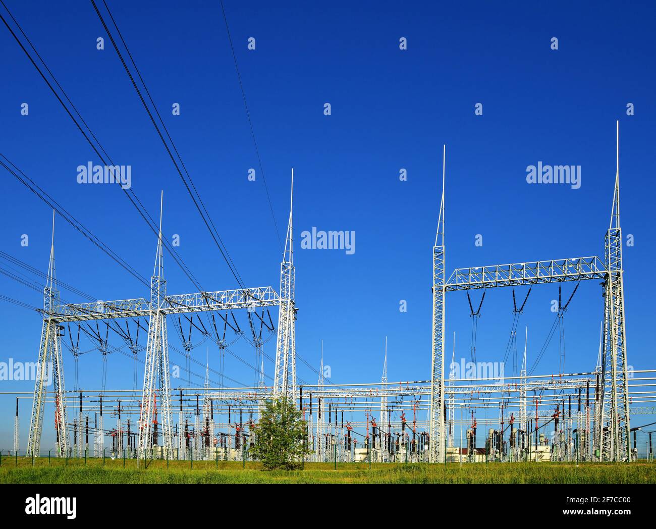 High voltage power substation on blue sky background Stock Photo - Alamy