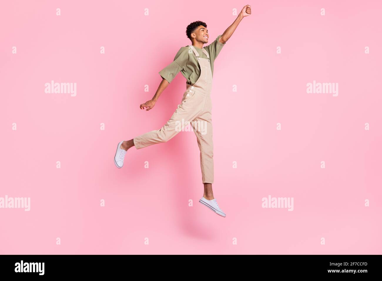 Profile photo of guy jump raise hand look empty space wear beige ...