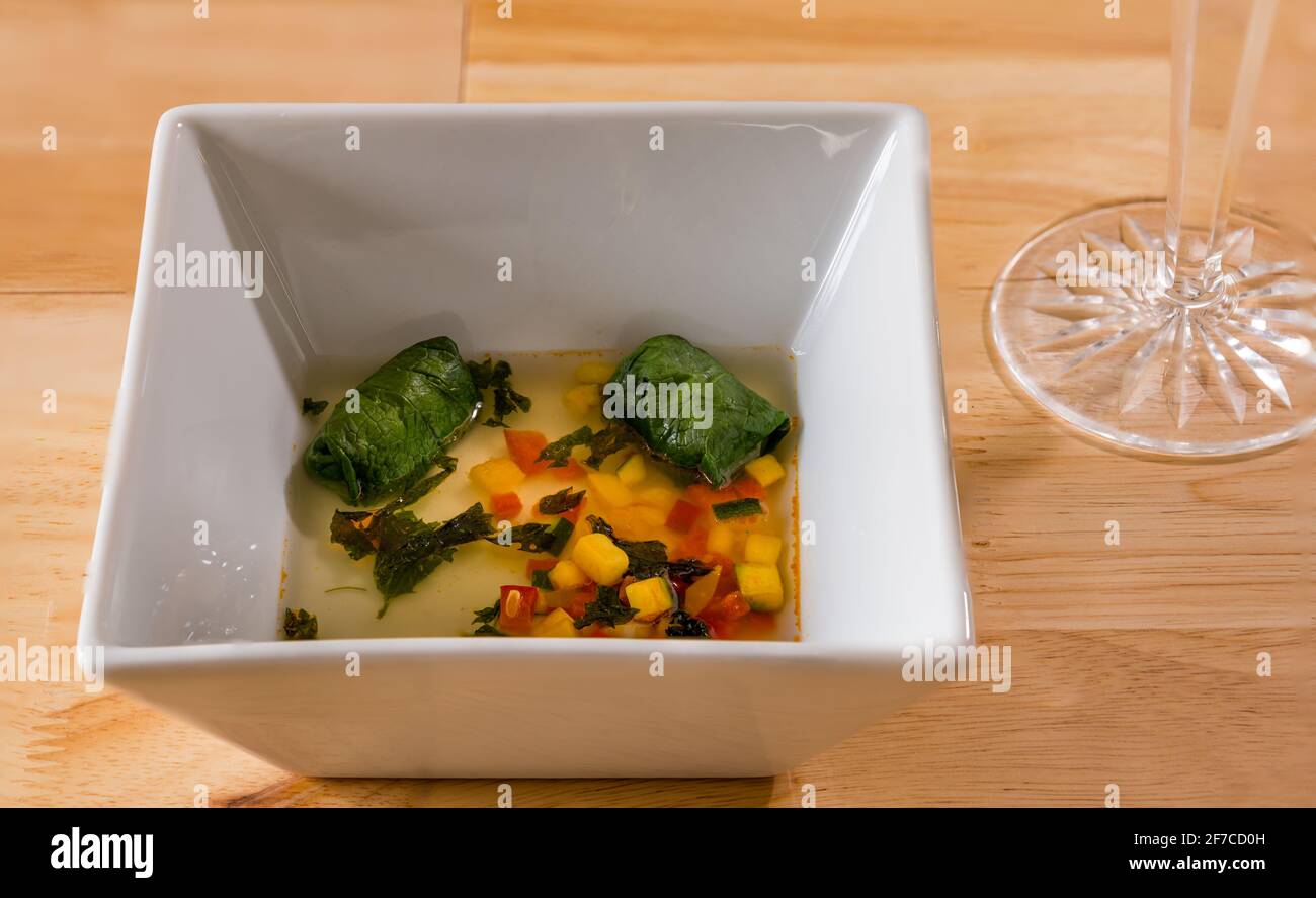 Tasting menu fine dining starter course served in white bowl with ...