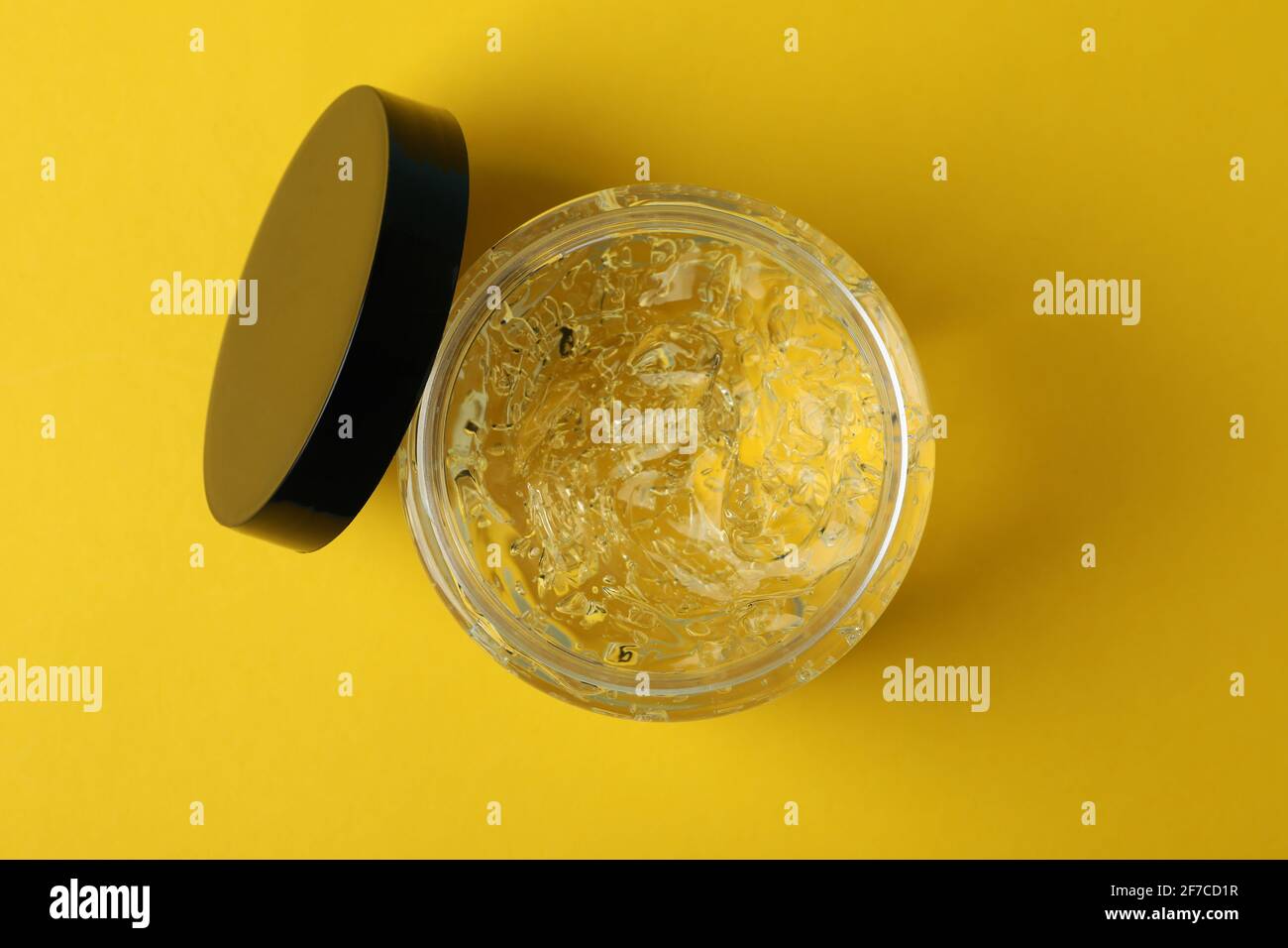Jar of styling gel on yellow background Stock Photo - Alamy