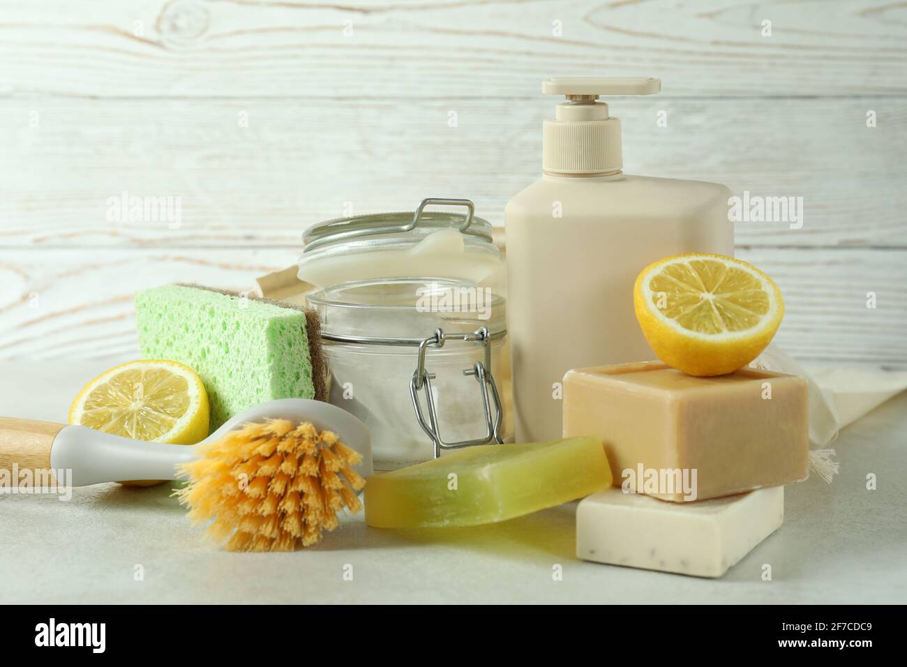 Eco friendly cleaning tools against wooden background Stock Photo - Alamy