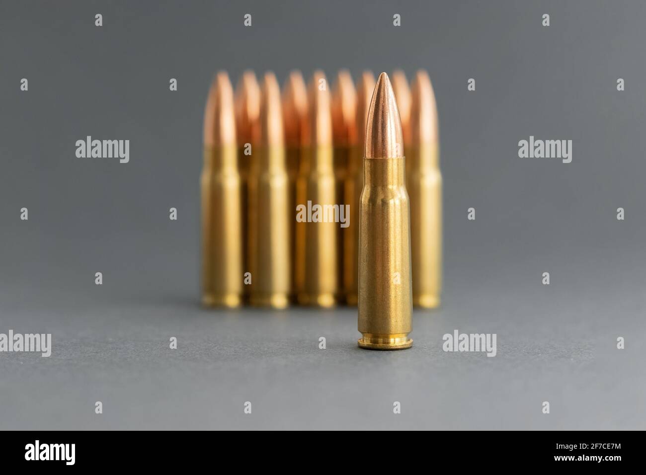 Bullets on gray background. Cartridges 7.62 caliber for Kalashnikov ...