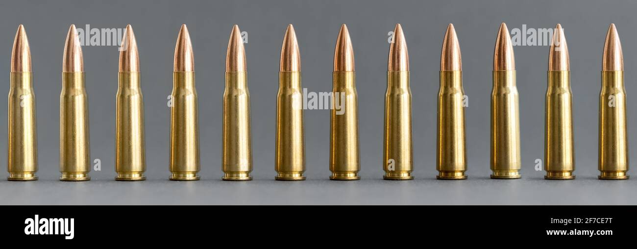 Bullets on gray background. Cartridges 7.62 caliber for Kalashnikov ...