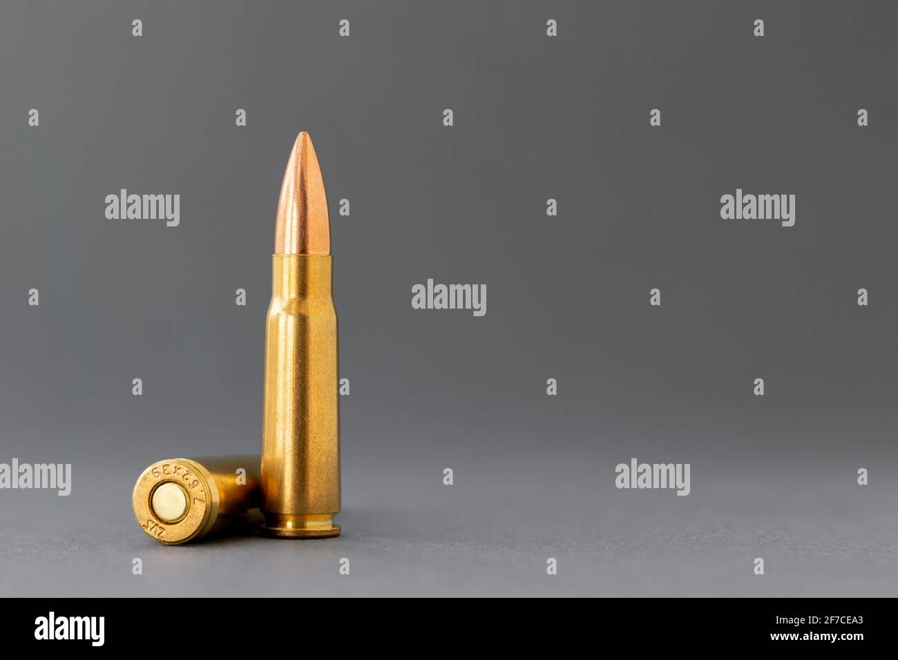 Two bullets on gray background. Cartridges 7.62 caliber for Kalashnikov ...