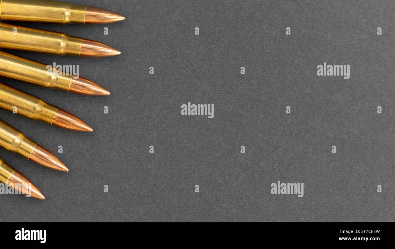 Bullets on gray paper background. Cartridges 7.62 caliber for ...