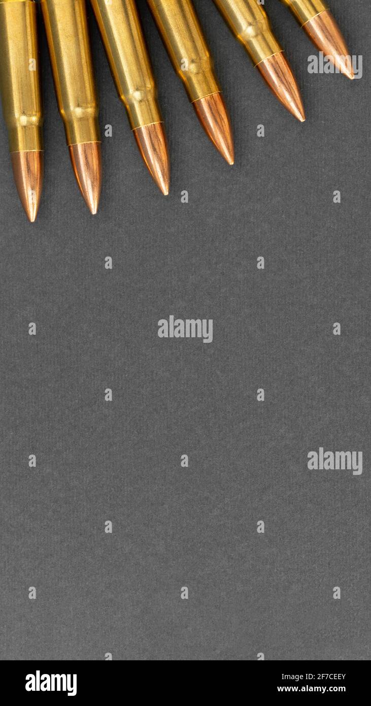 Bullets on gray paper background. Cartridges 7.62 caliber for ...