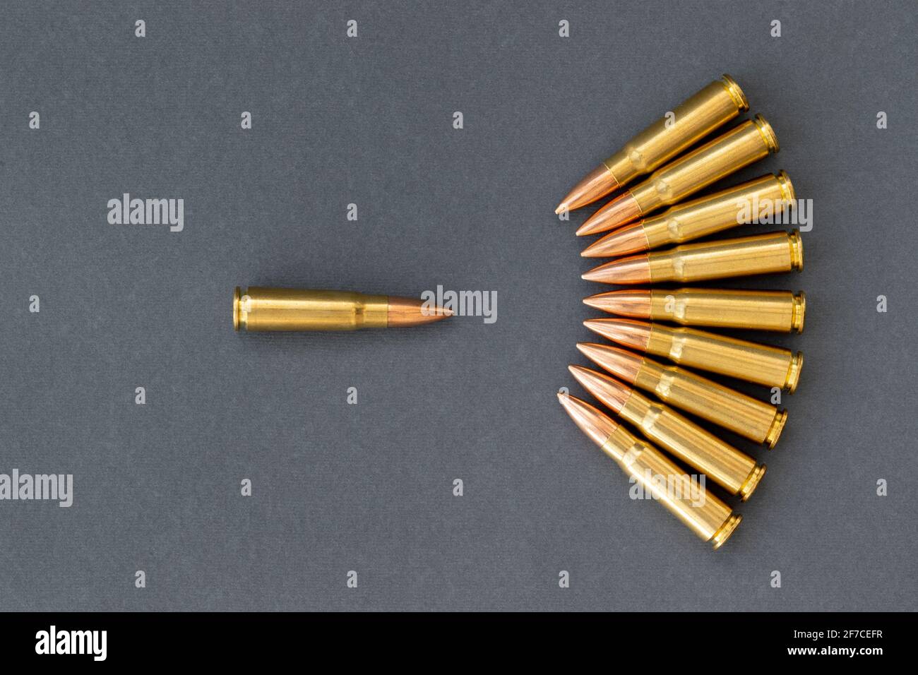 Bullets on gray paper background, one bullet in front of the others ...