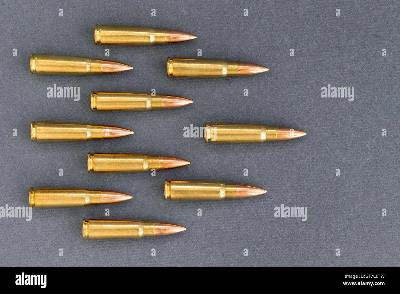 Bullets on gray paper background. Cartridges 7.62 caliber for ...