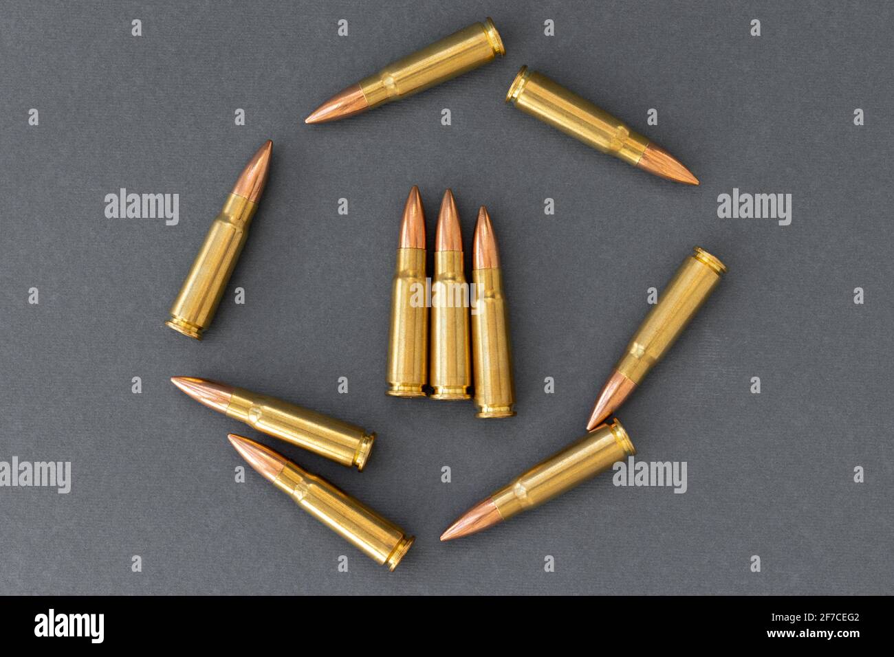 Group of bullets on gray paper background. Cartridges 7.62 caliber for ...