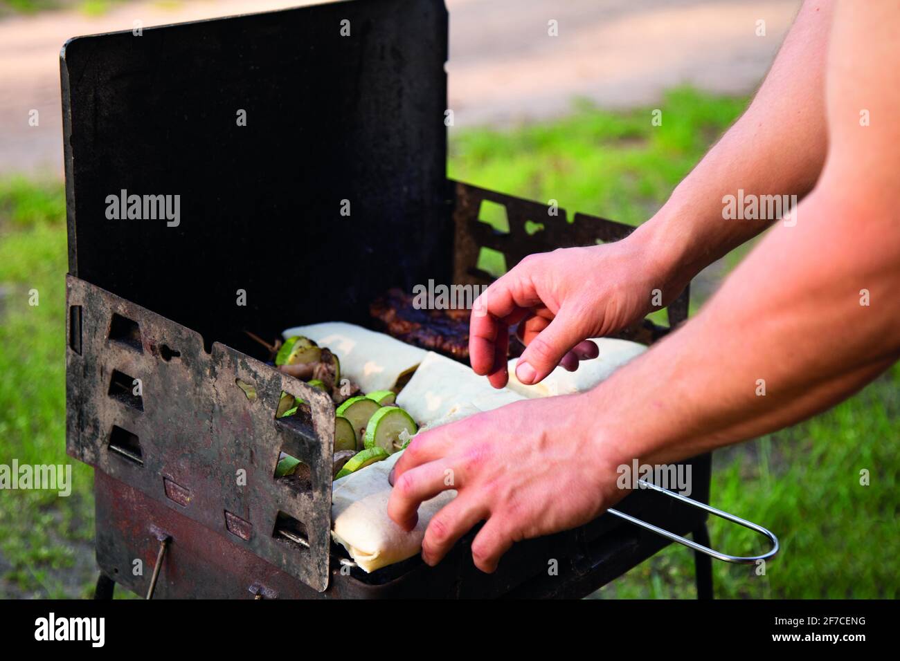 Happy man doing barbecue family hi-res stock photography and images - Alamy