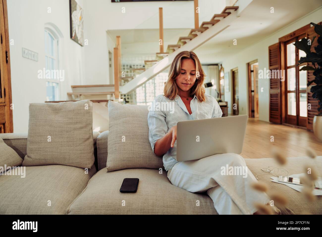 Woman sitting inside room on hi-res stock photography and images - Alamy