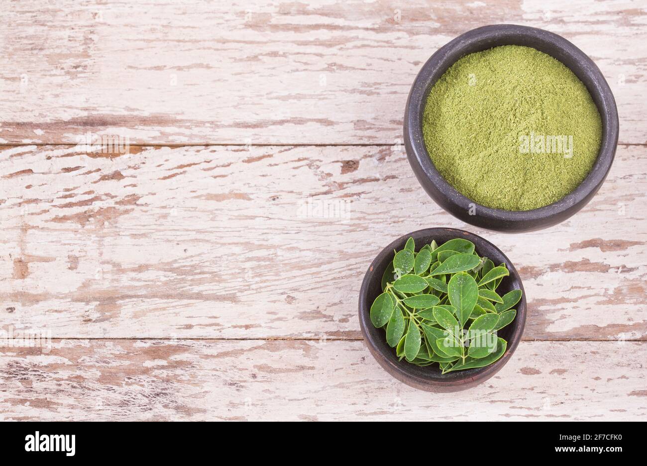 Fresh leaves and moringa powder - Moringa oleifera. Top view Stock ...