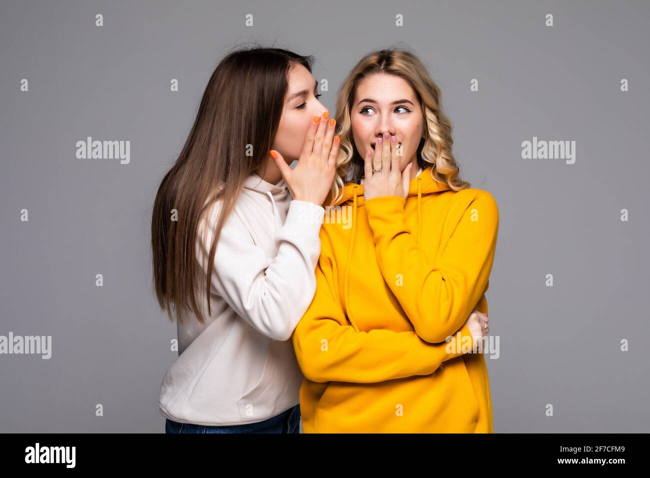 A couple of beautiful young Women gossiping Stock Photo - Alamy