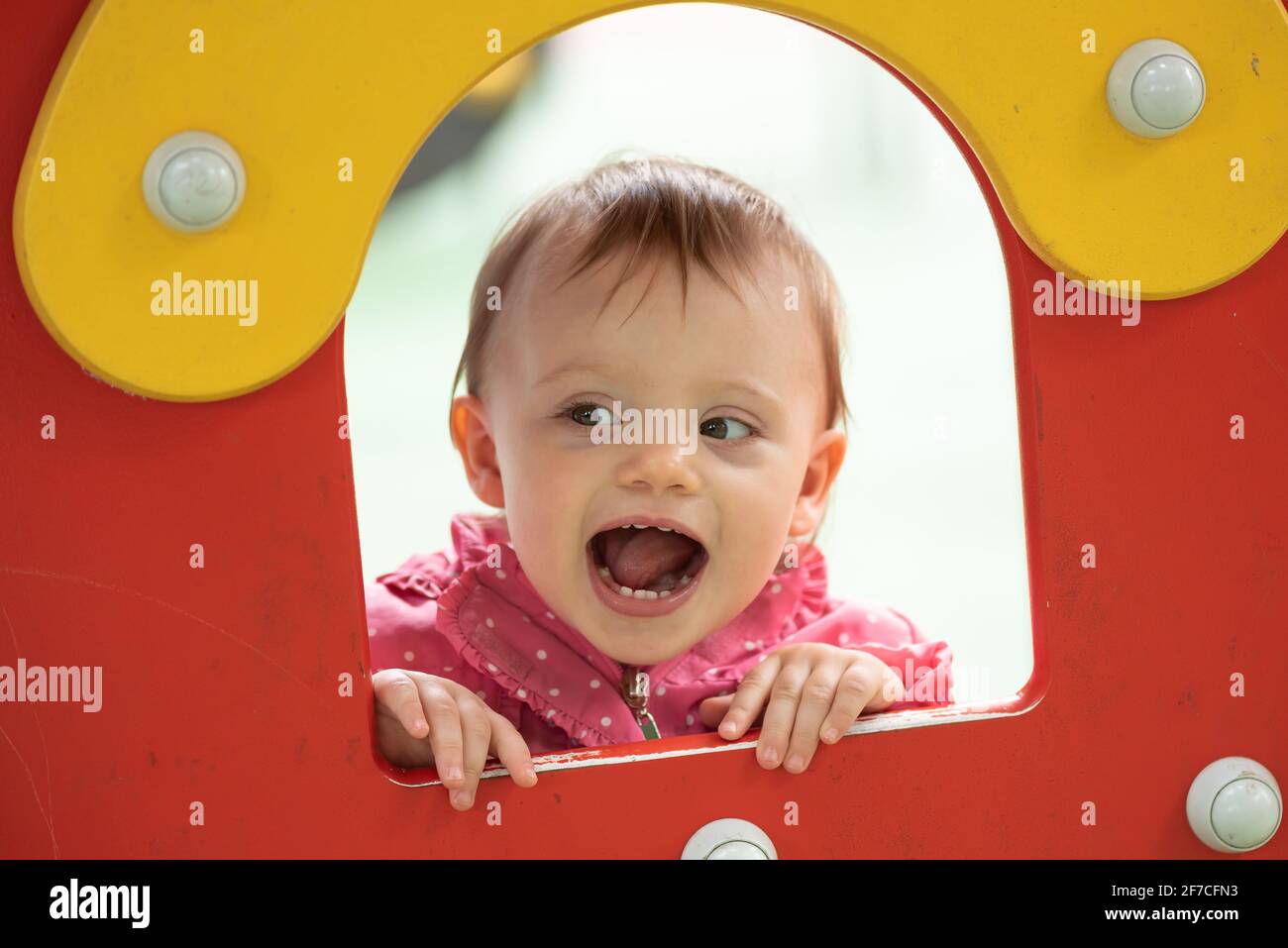 Cute baby girl having fun on a playground Stock Photo - Alamy