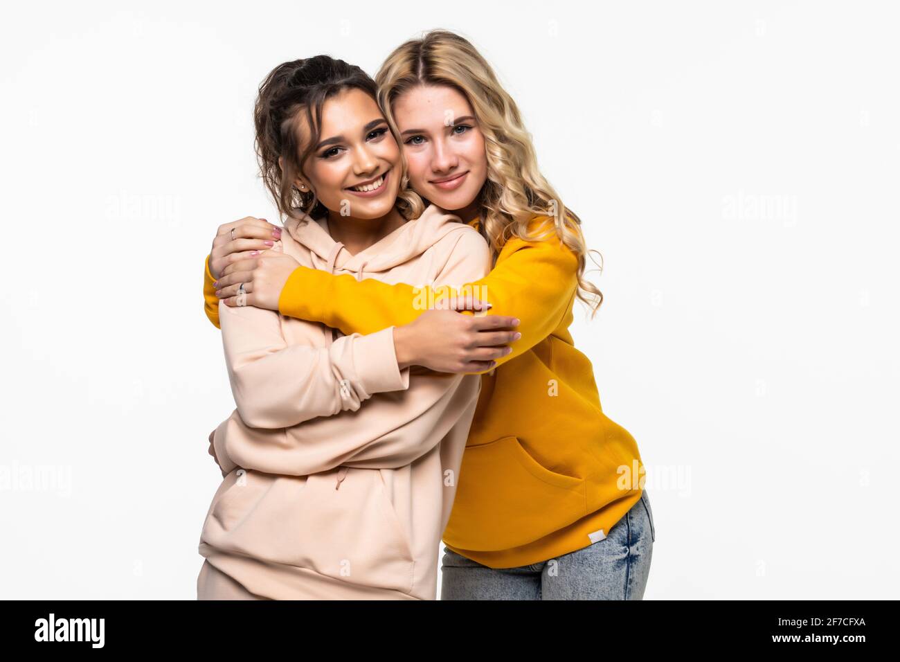 Portrait of two women smiling hugs and having fun, isolated on white ...