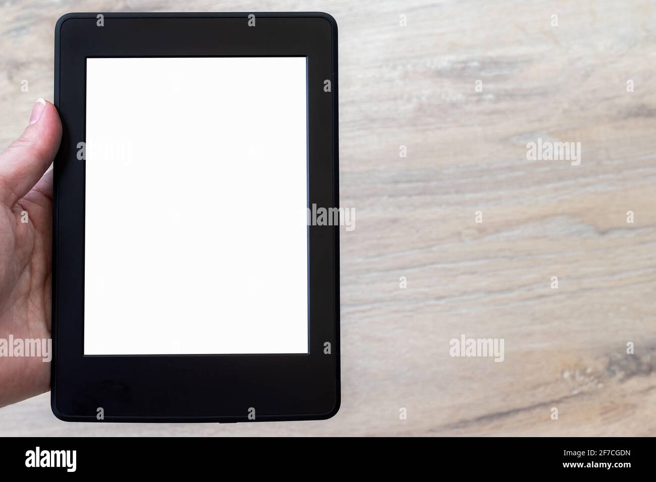 A modern black electronic book with a white blank empty screen in human ...