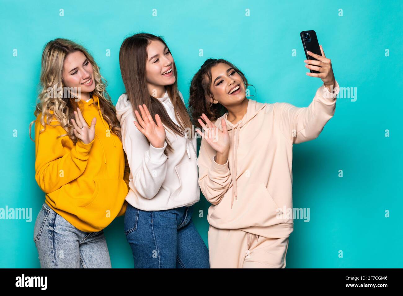 Young three multiethnic girls friends take a selfie by camera posing ...