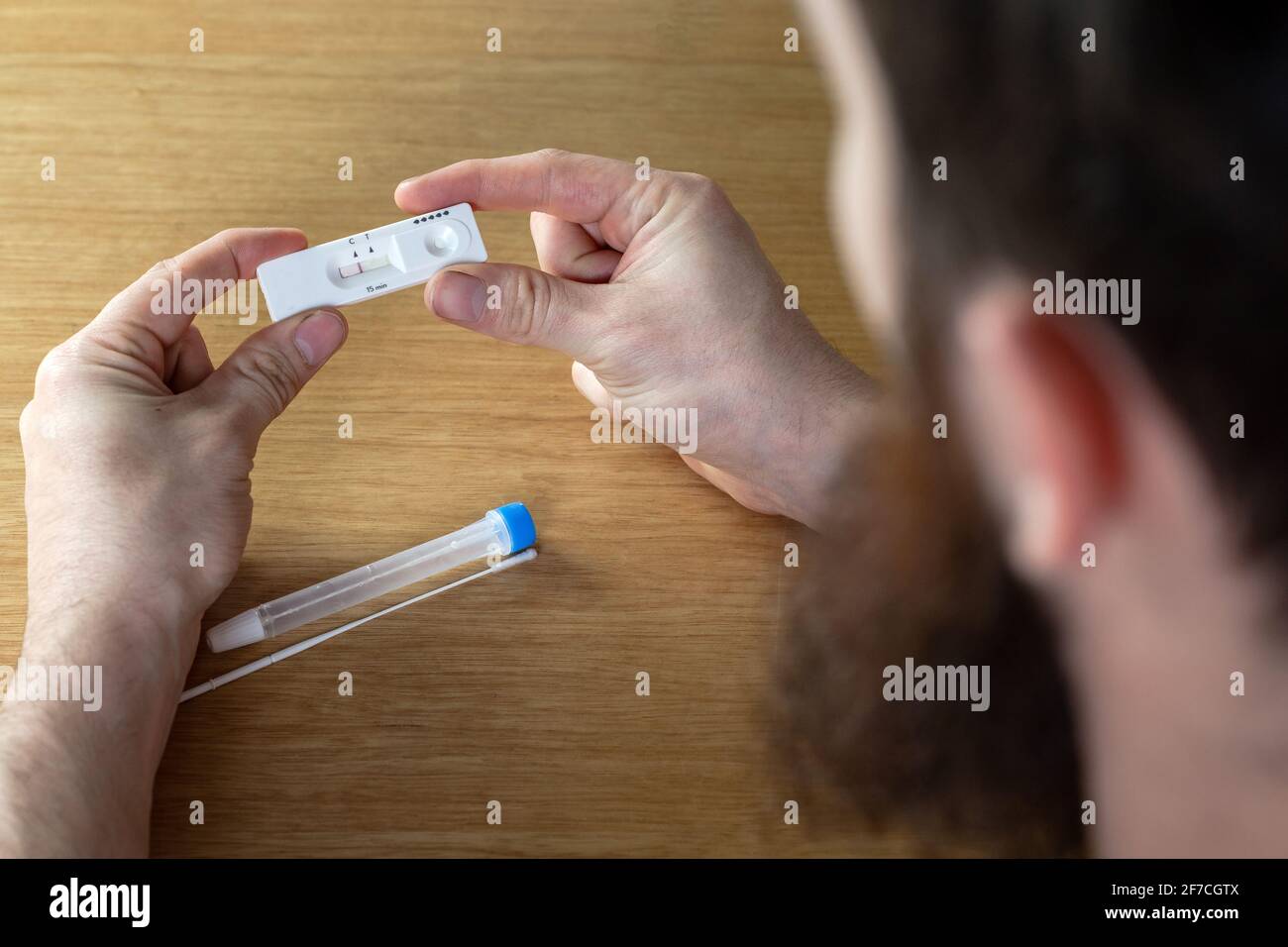 Young man holding a negative covid-19 self test at home, self test kit ...