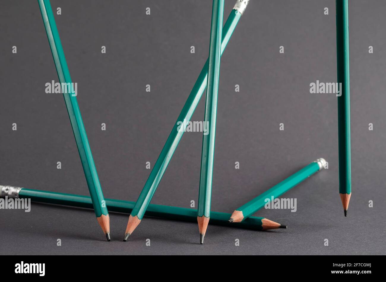 Abstract geometric composition with standing pencils on a gray ...