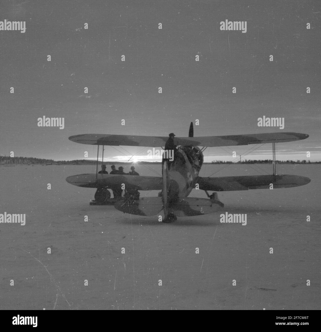 Airplane Gloster Gladiator starts in backlight from F 19 . Airplane ...