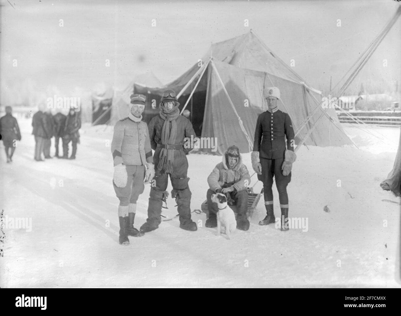 Portrait four men in front of tenthangar portrait. Four men and a dog ...