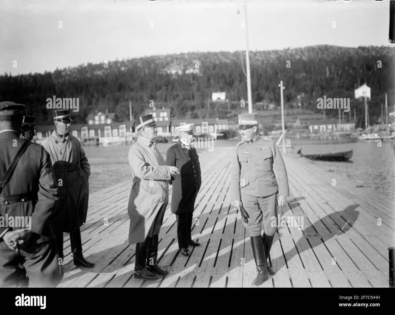 Commanding on bridge five men on a dock. Third from left: General Carl ...