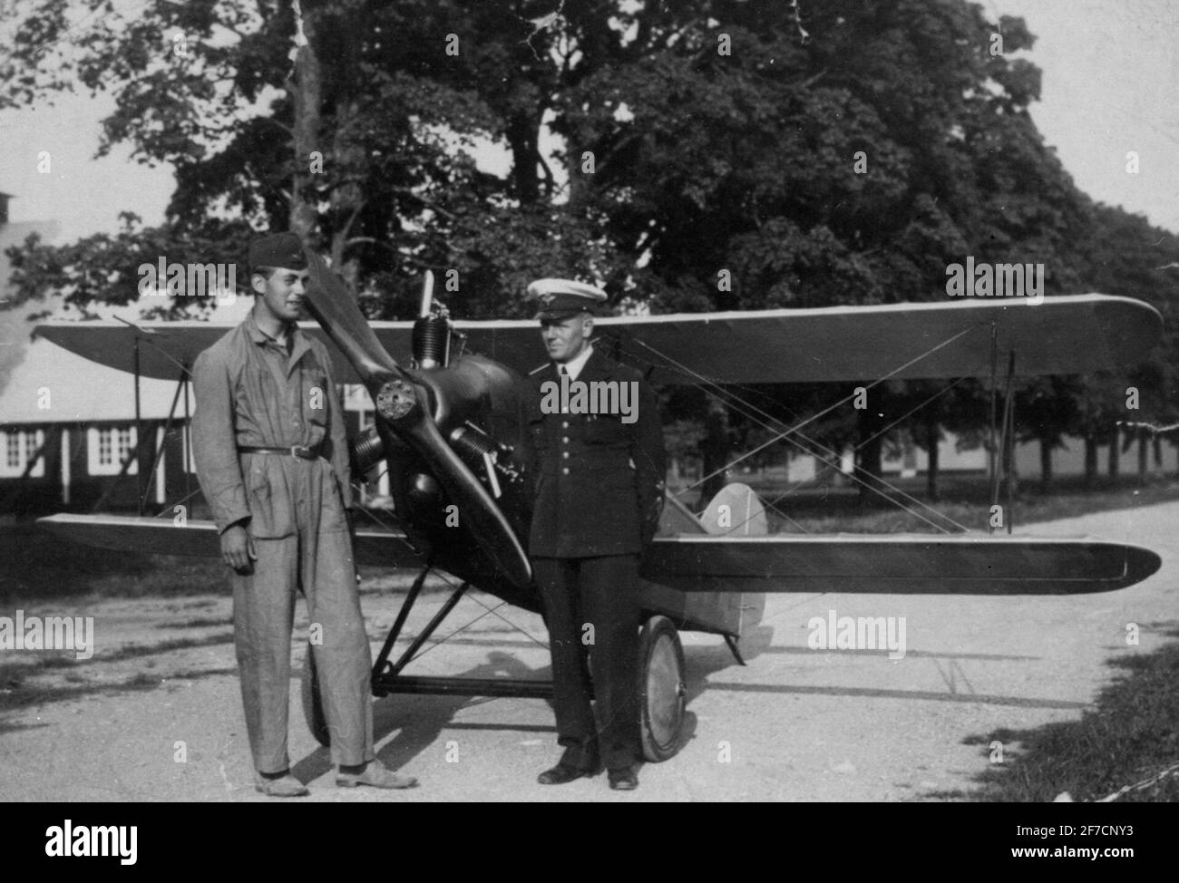 Two military people in front of the civil aircraft Holmberg Racer, 1937 ...