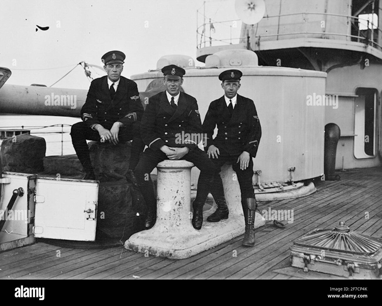 Three marine officers are sitting on a pale tire three marine officers ...