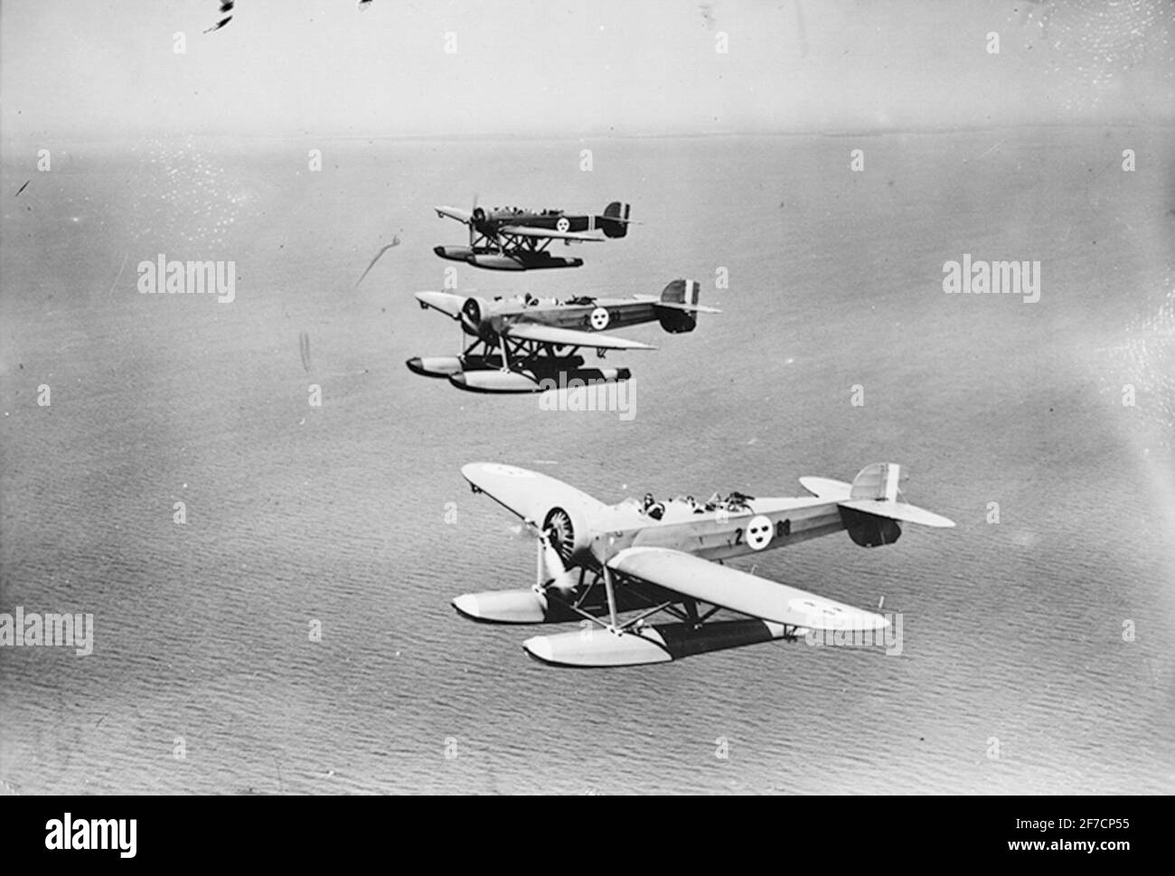 Three aircraft surveying aircraft 5 from f 2 in the air over water ...