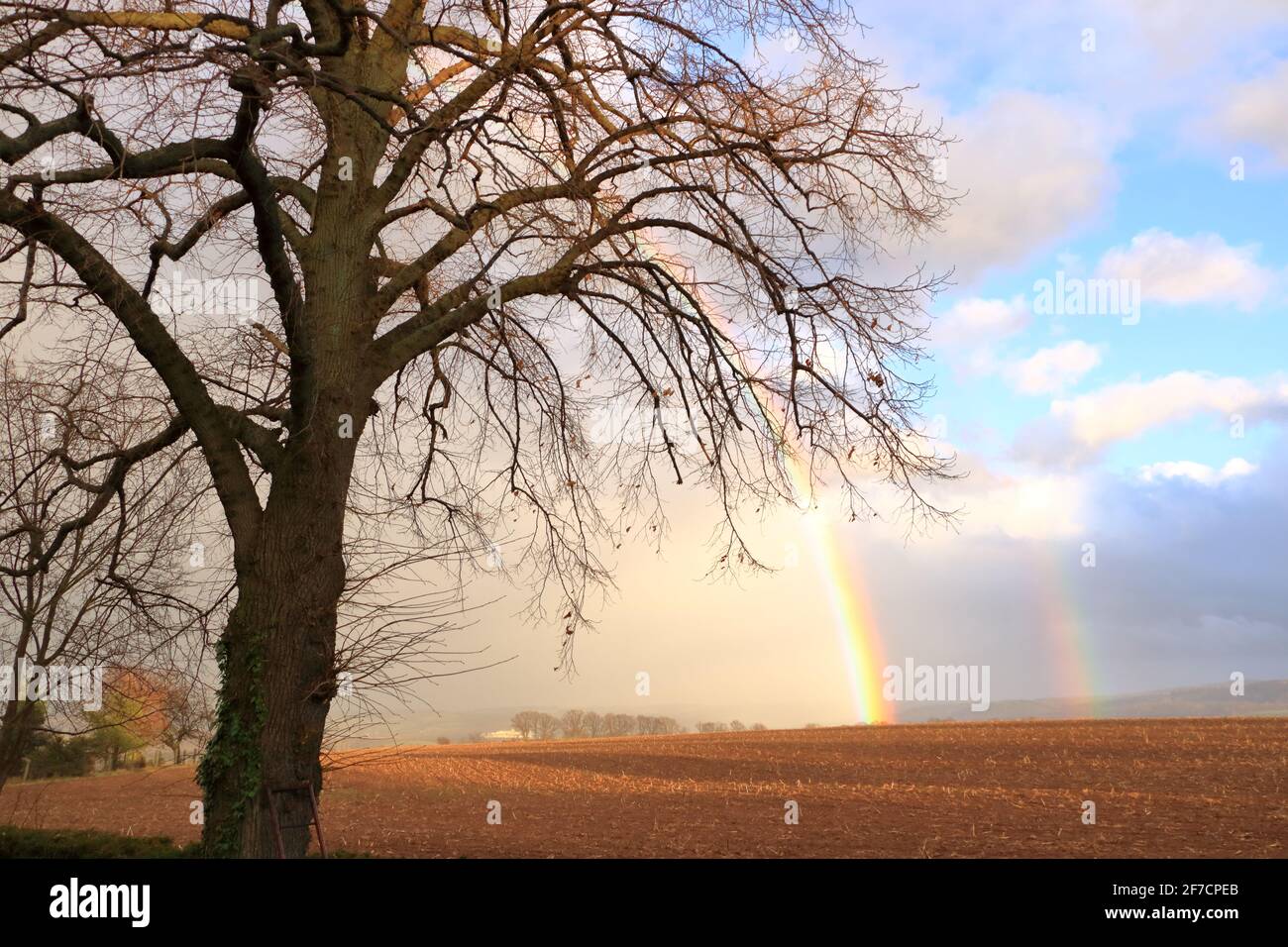 Rainbow over stormy sky. Rural landscape with rainbow over a dark ...