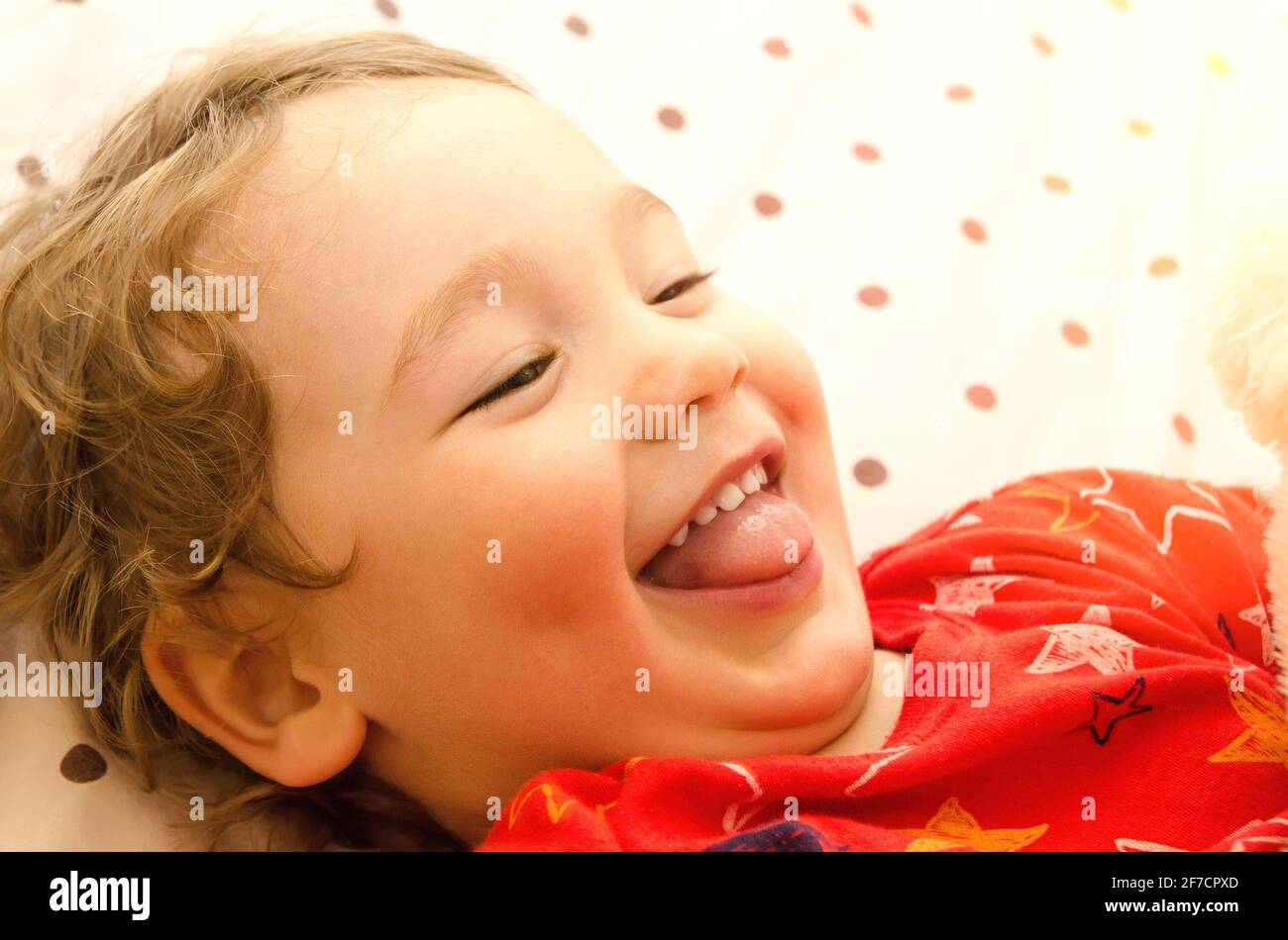 little boy smiling on the bed Stock Photo - Alamy