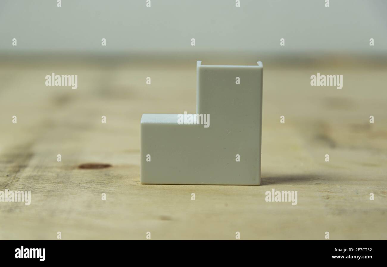 Electrical connector type elbow 90 degrees on wooden background ...