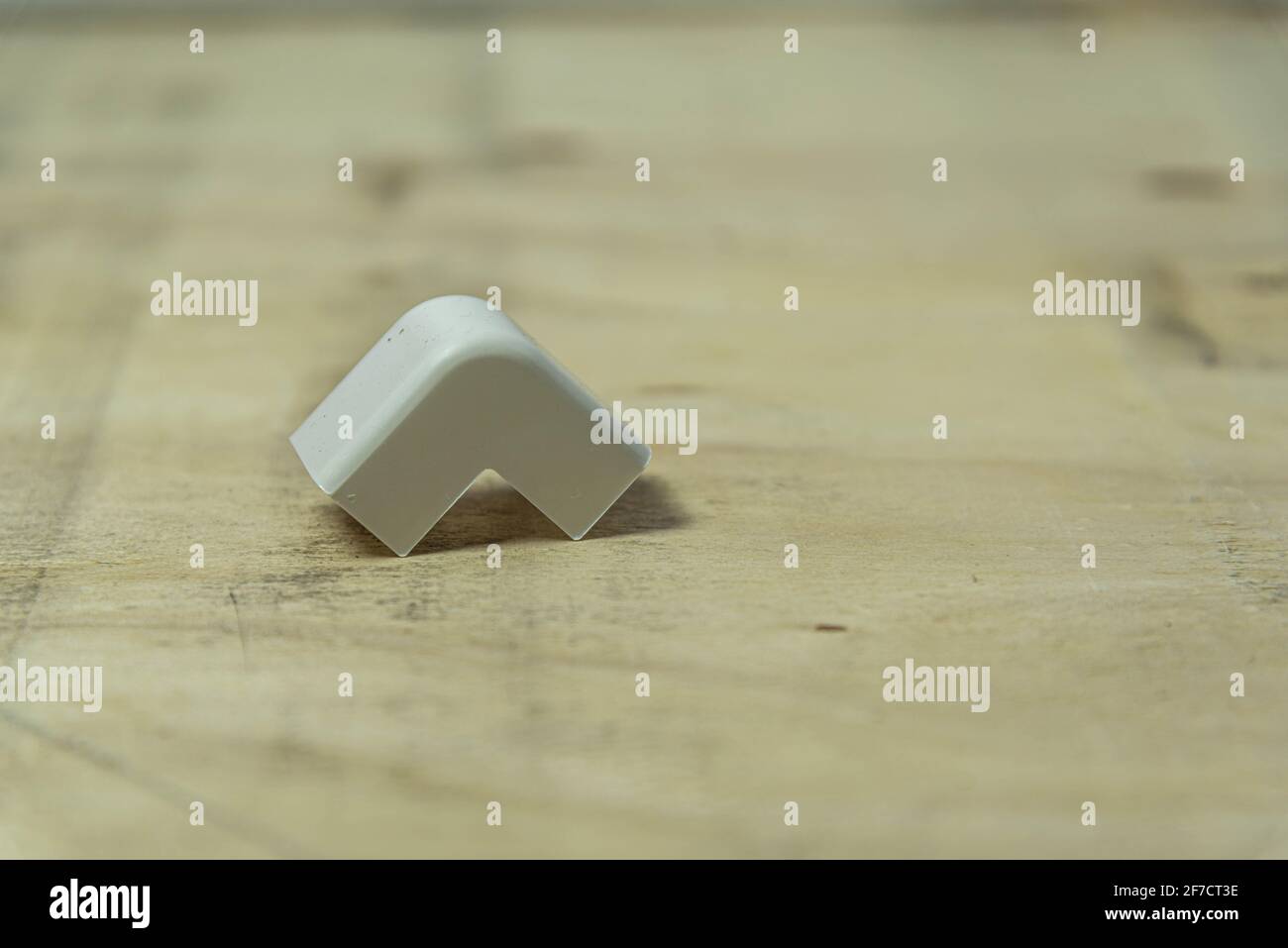 Electrical connector type elbow 90 degrees on wooden background ...